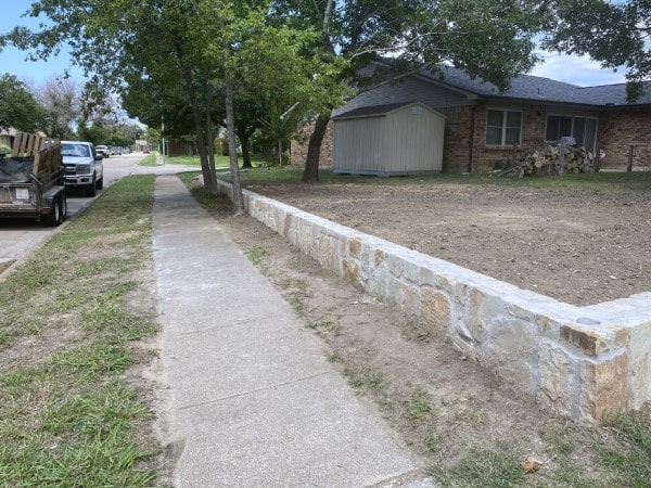 Before Replaced wood wall with Milsap stone wall Carrollton Texas